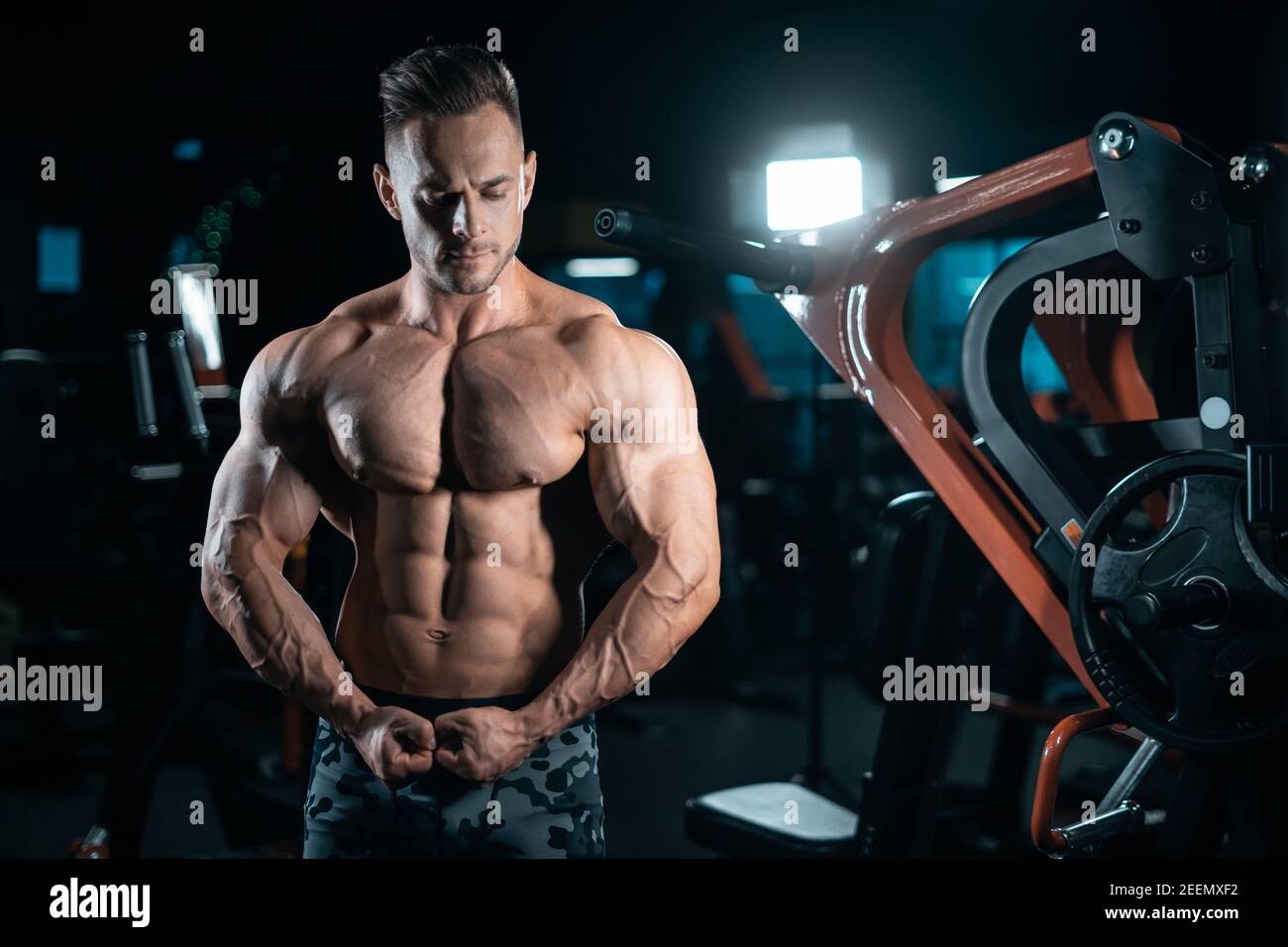 young athletic sportsman bodybuilder with muscle perfect body posing in ...