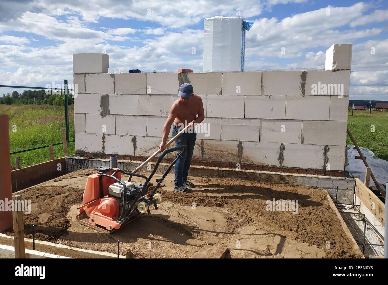 Vibrating plate in use, the worker with the help of a vibrating plate ...