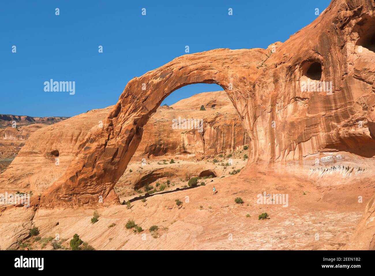 Corona Arch hiker heads under the arch during a three mile round trip ...