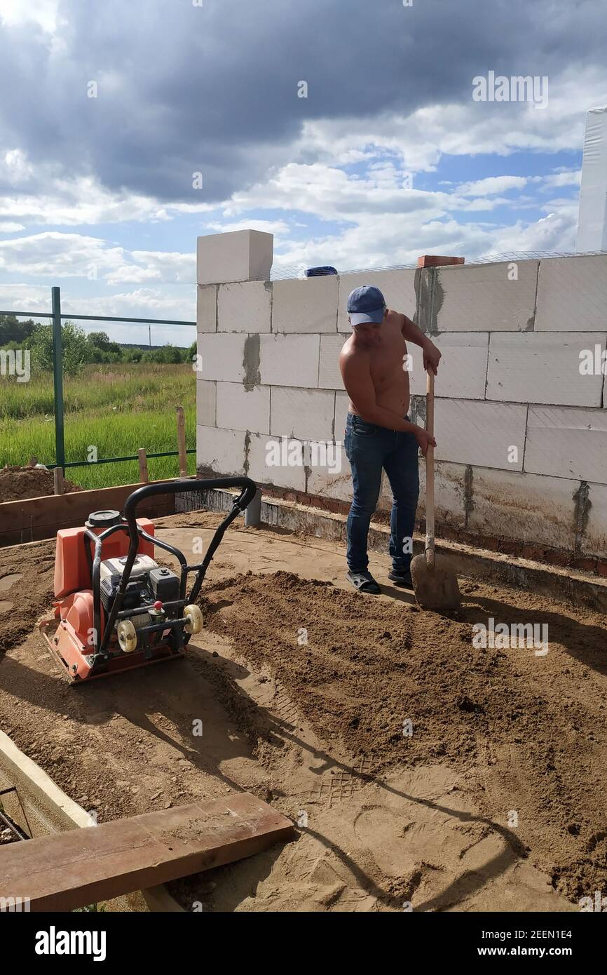 Vibrating plate in use, the worker with the help of a vibrating plate ...