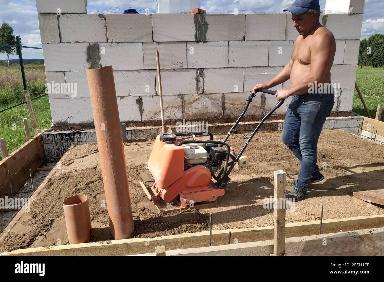 Vibrating plate in use, the worker with the help of a vibrating plate ...