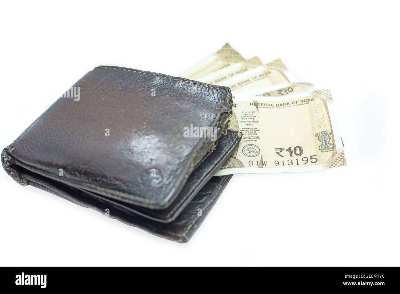 Some Indian cash money in a black worn-out wallet on the white ...
