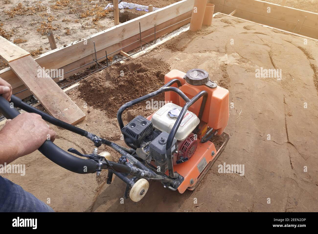 Working with a vibrating machine and equipment, soil compaction with a ...