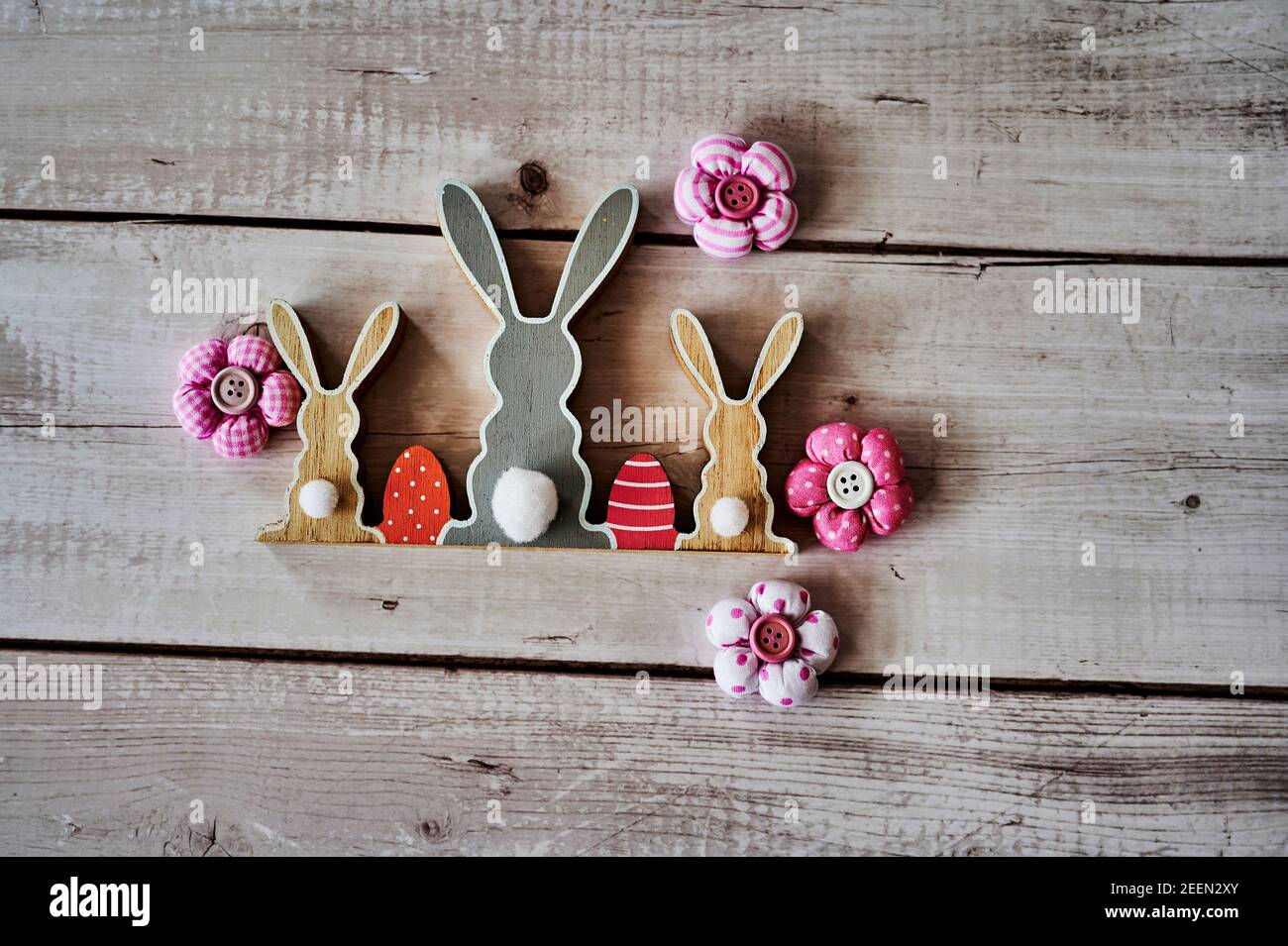 Three wooden Easter bunnies from behind with decoration Stock Photo - Alamy