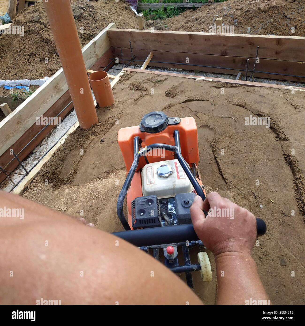 Working with a vibrating machine and equipment, soil compaction with a ...