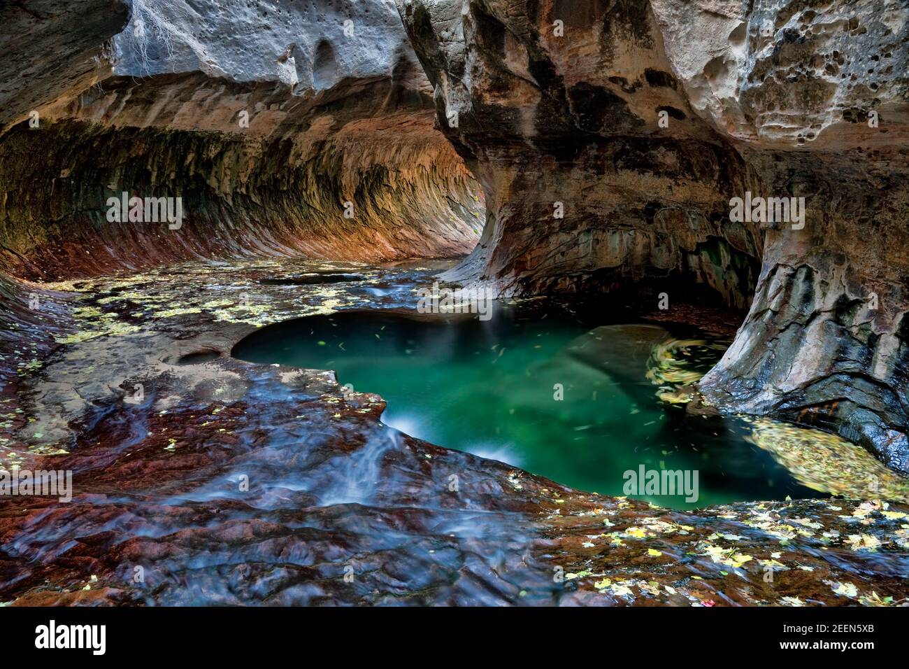 Green pools, flowing water and a circular rock formation at the Subway ...