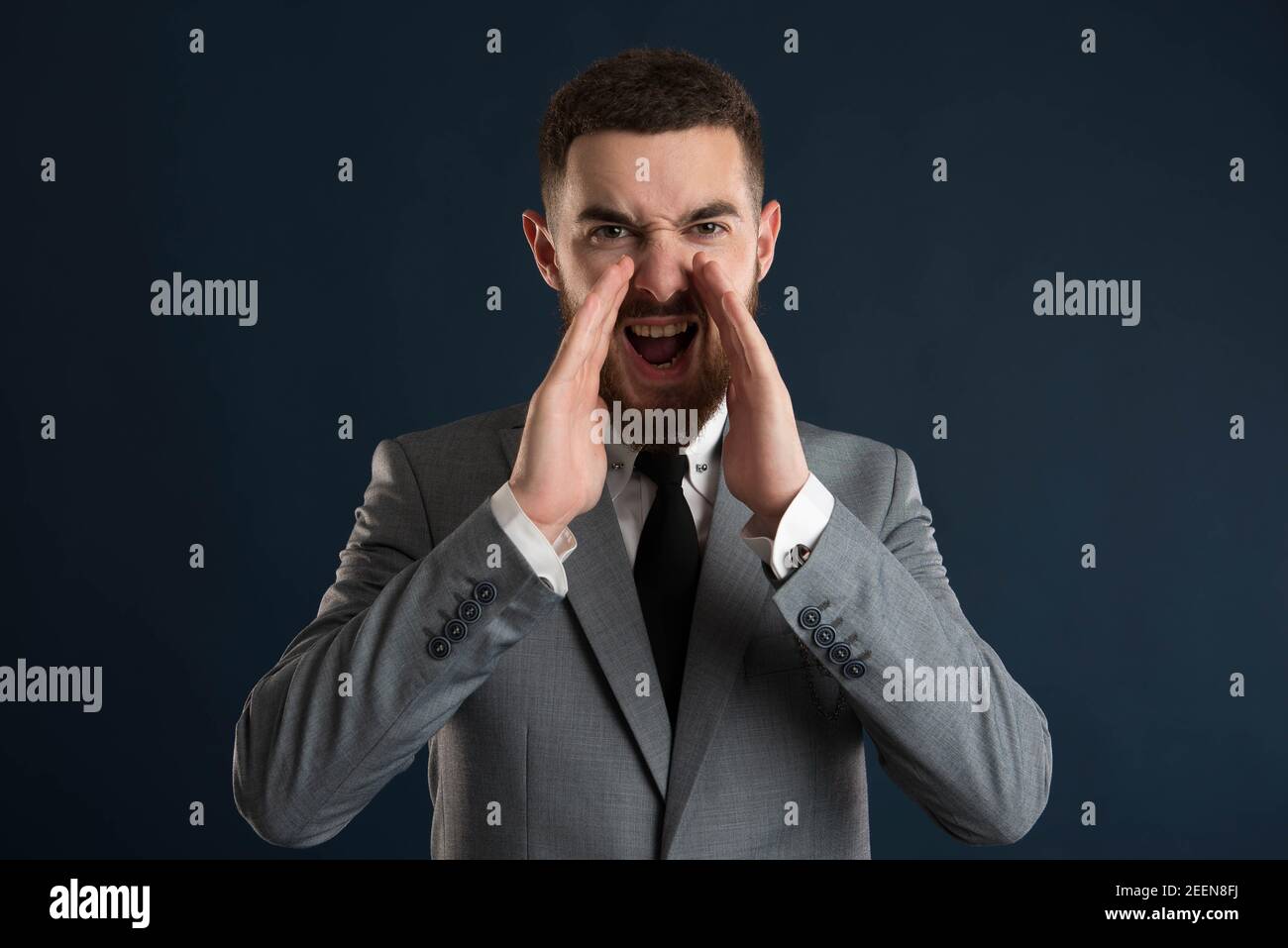 Young businessman shouting at you wearing a suit and tie Stock Photo ...