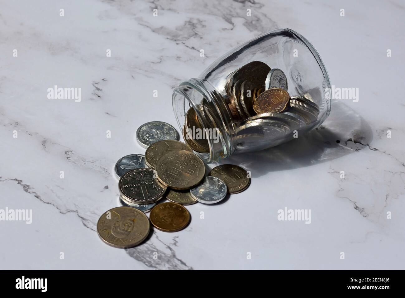 Chinese yuan coin on the table surface with a jar Stock Photo - Alamy