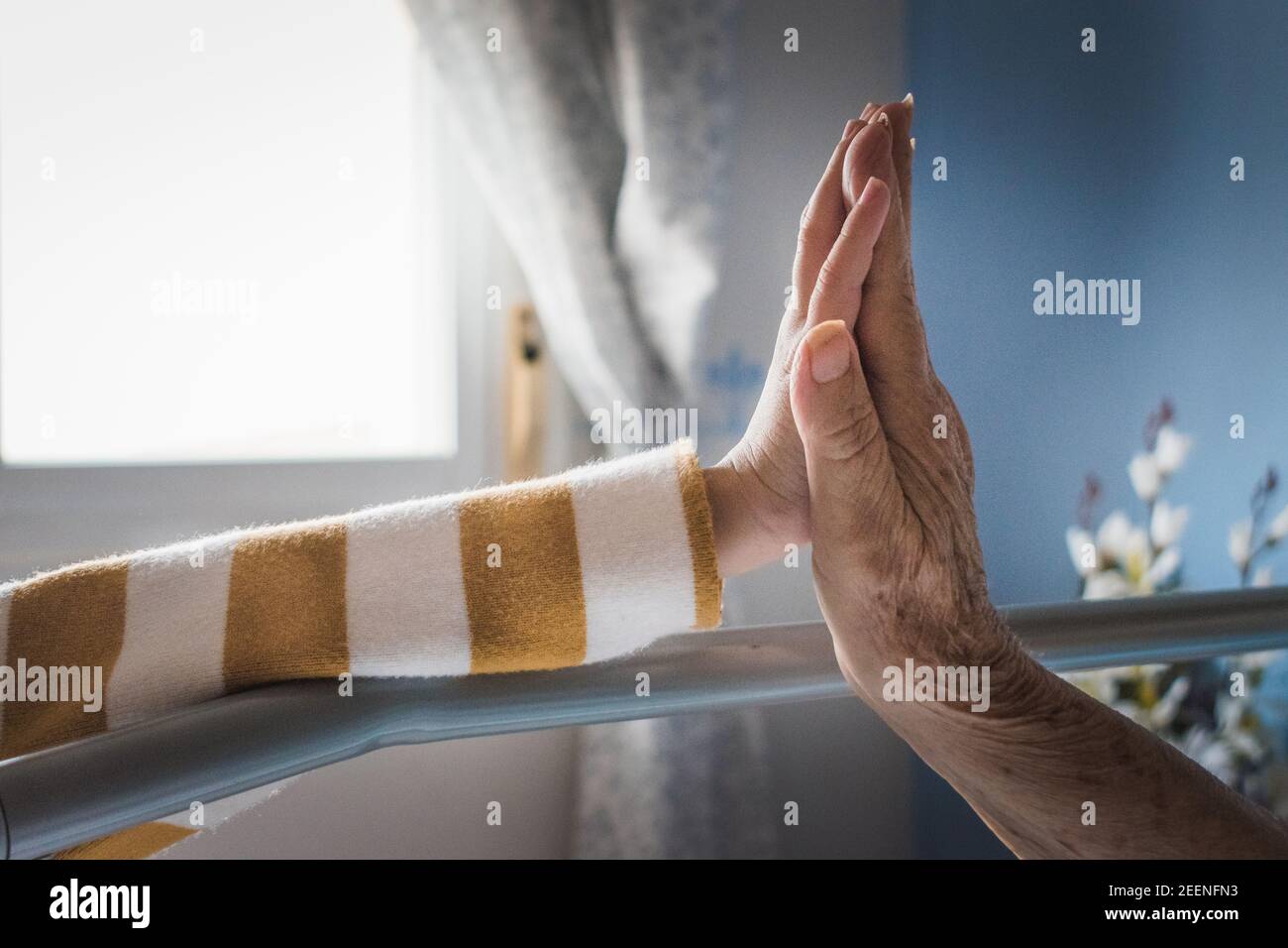 two hands colliding on a bed Stock Photo - Alamy