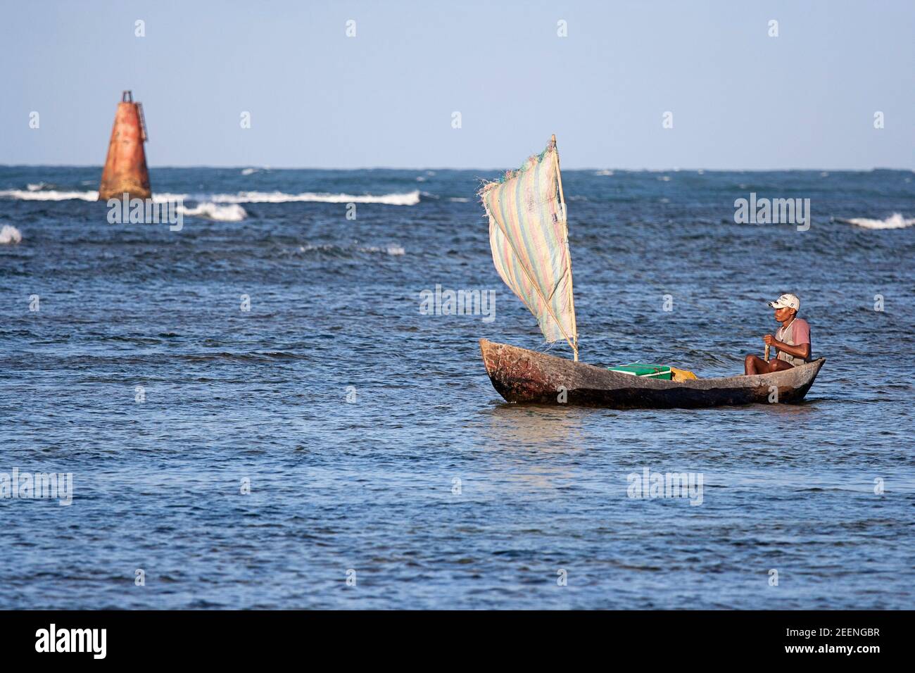 Fisherman in traditional wooden fishing boat, pirogue, canoe ...