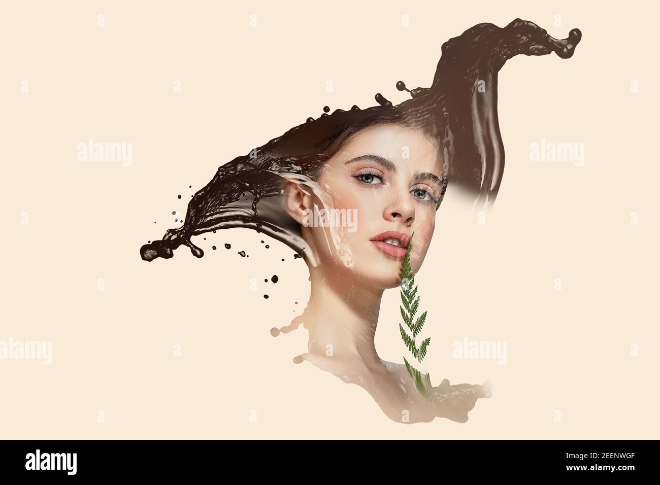 Reflection of a beautiful brunette girl in a water splash on a beige ...