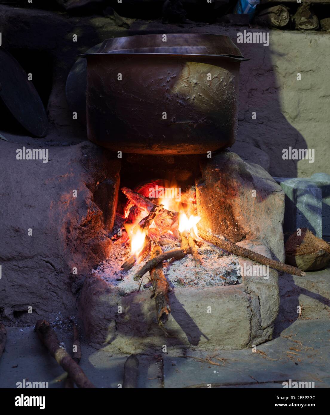 Water boiling over an earthen stove using wood sticks as fuel Stock ...