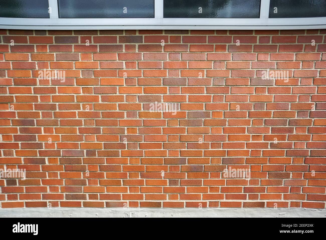 View of glass windows below a brick wall background Stock Photo - Alamy