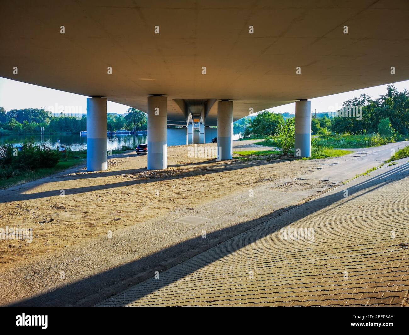 Concrete pillars under bridge on beach near river Stock Photo - Alamy