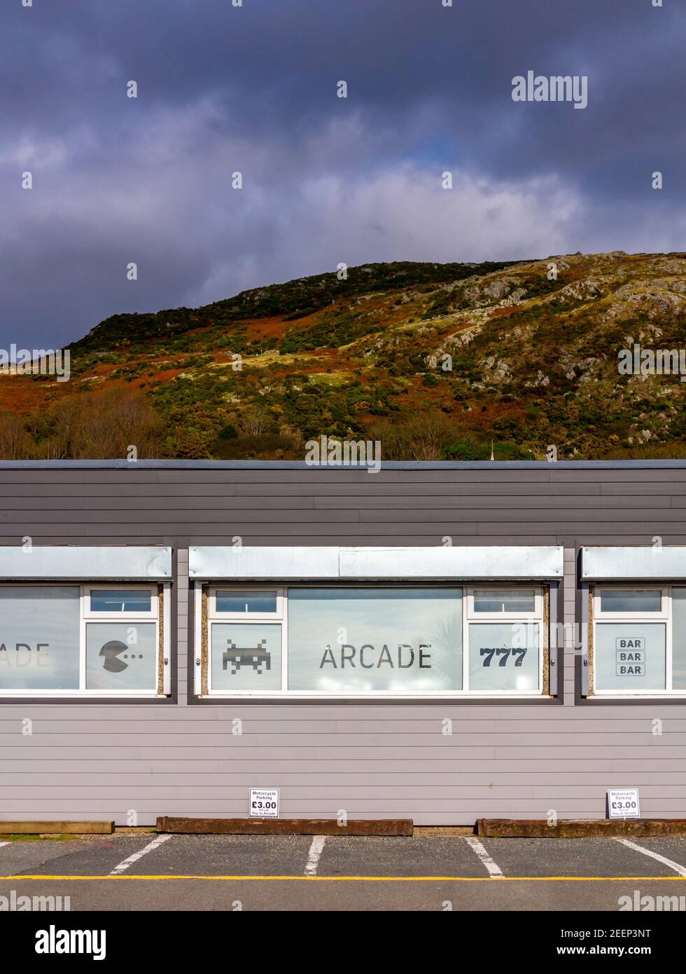 Parking bays outside amusement arcade on the seafront at Barmouth in ...