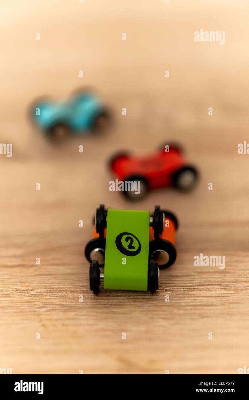 Selective focus shot of small flat colorful toy cars with numbers on ...