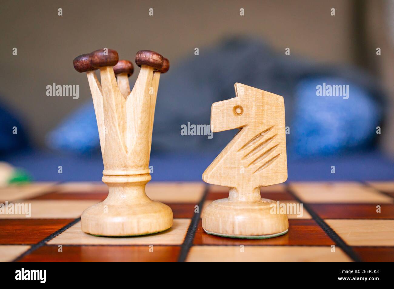 Wooden chess piece queen and a knight on a chessboard Stock Photo - Alamy