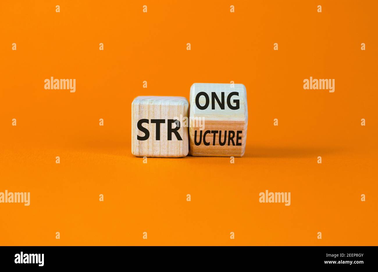 Strong structure symbol. Turned a wooden cube with words 'strong ...