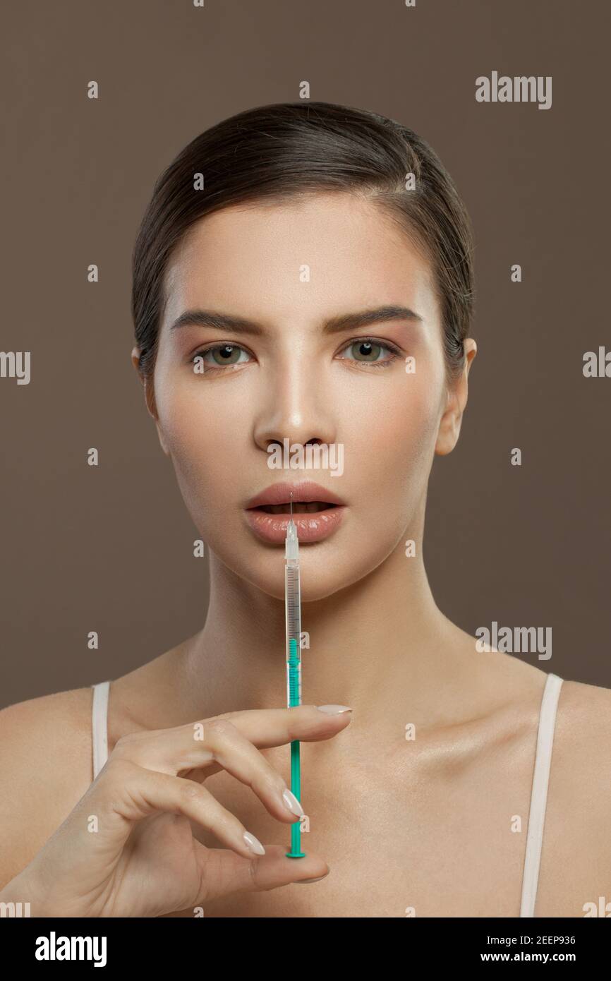 Female face and syringe. Lip augmentation concept Stock Photo - Alamy