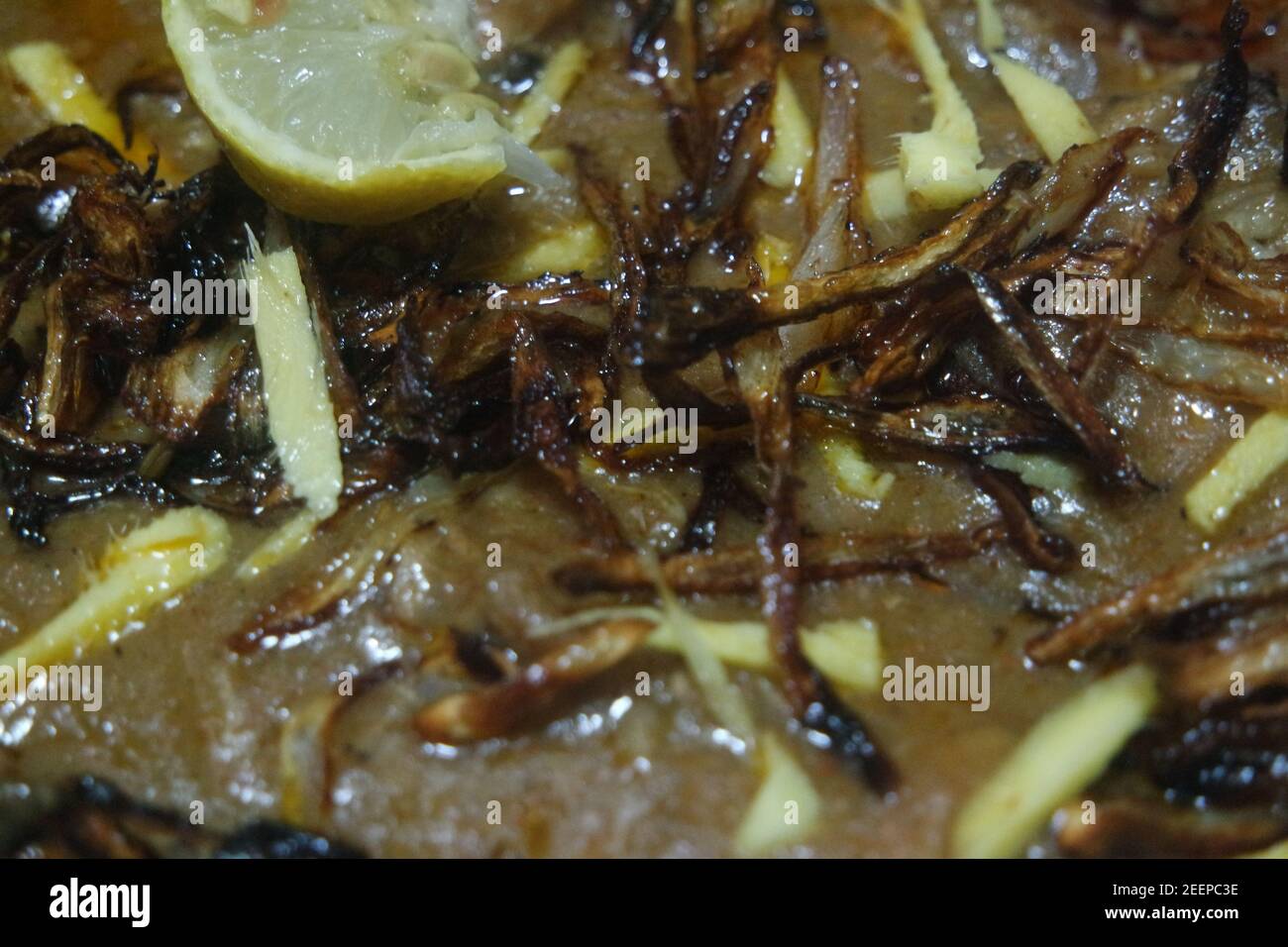Closeup shot of traditional Pakistani Haleem dish with salad and lemon ...