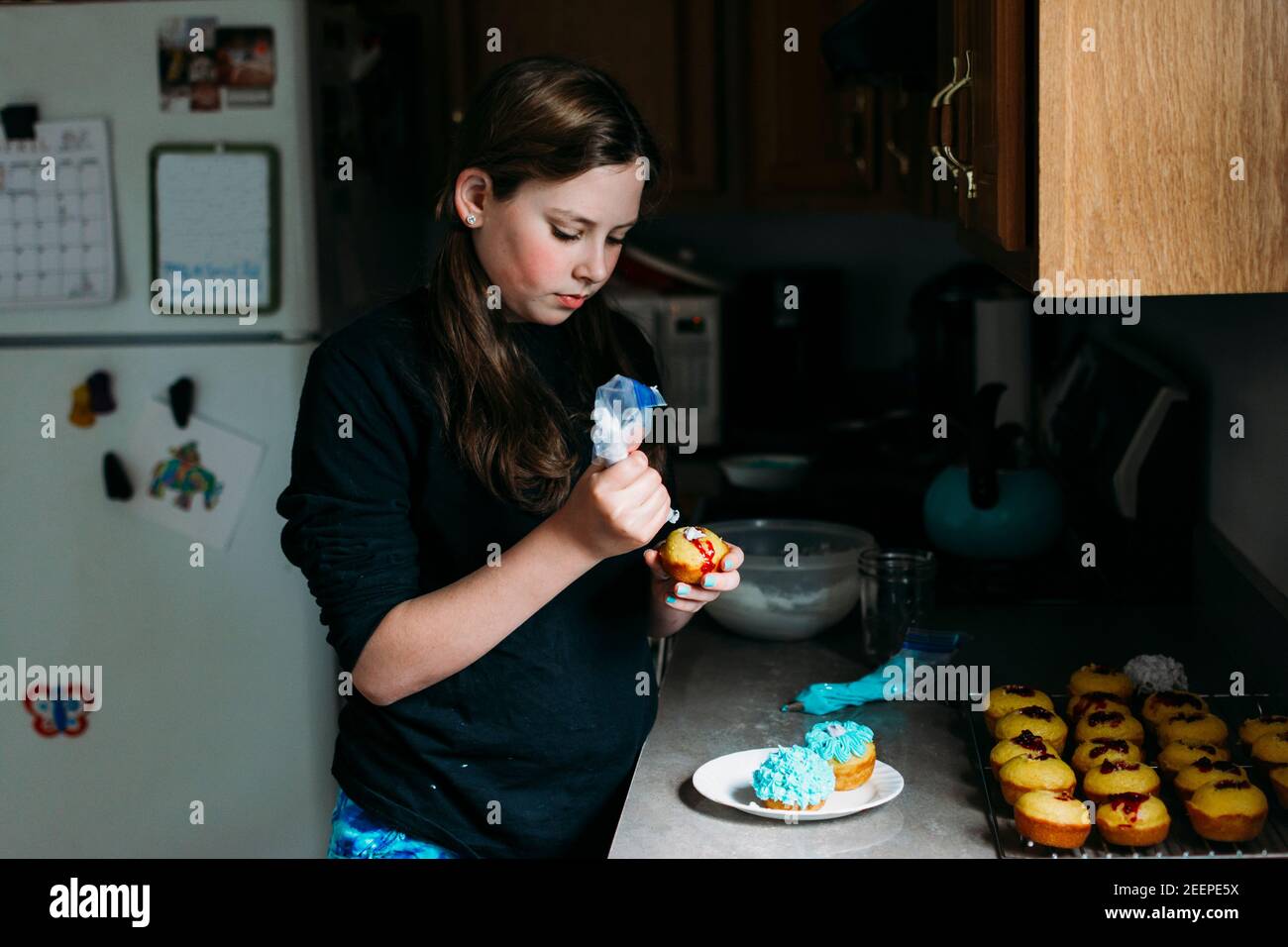 Teen girl decorating cake hi-res stock photography and images - Alamy