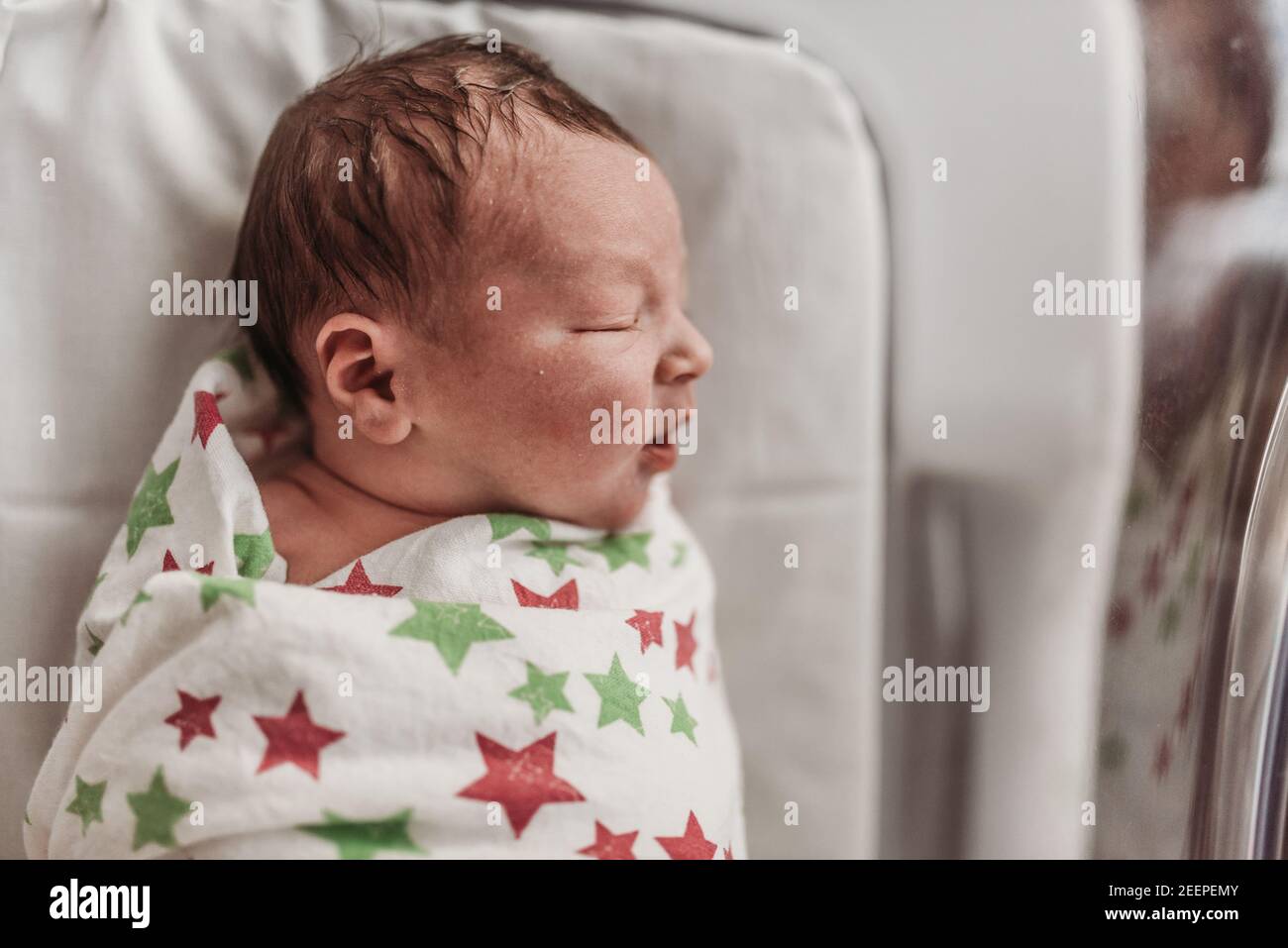 Side angle of newborn baby boy swaddled in birthing center Stock Photo ...
