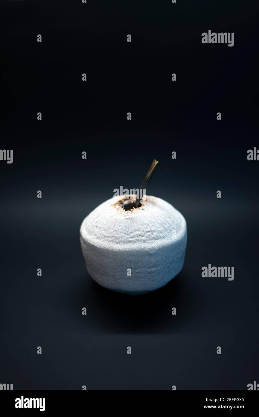 Peeled coconut with metal sustainable straw Stock Photo - Alamy