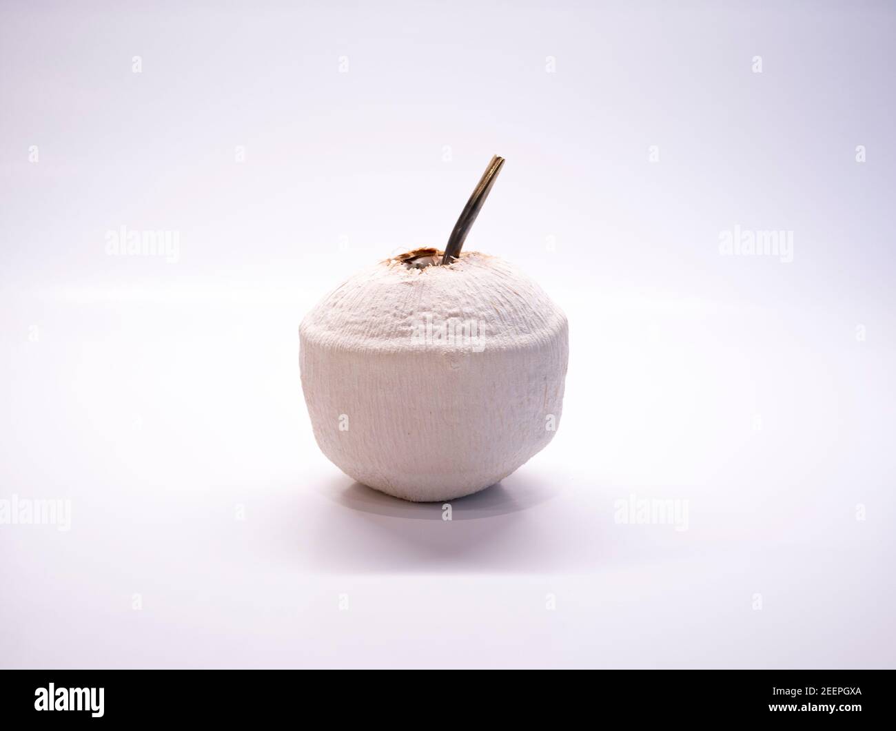 Peeled coconut with metal sustainable straw on a white background Stock ...