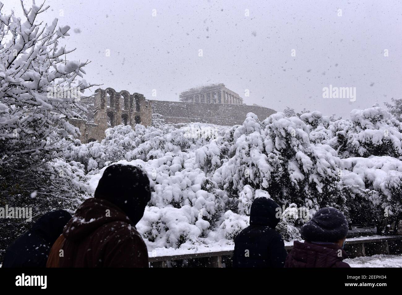 Athens, Greece. 16th Feb., 2021. People walk in a street covered in ...