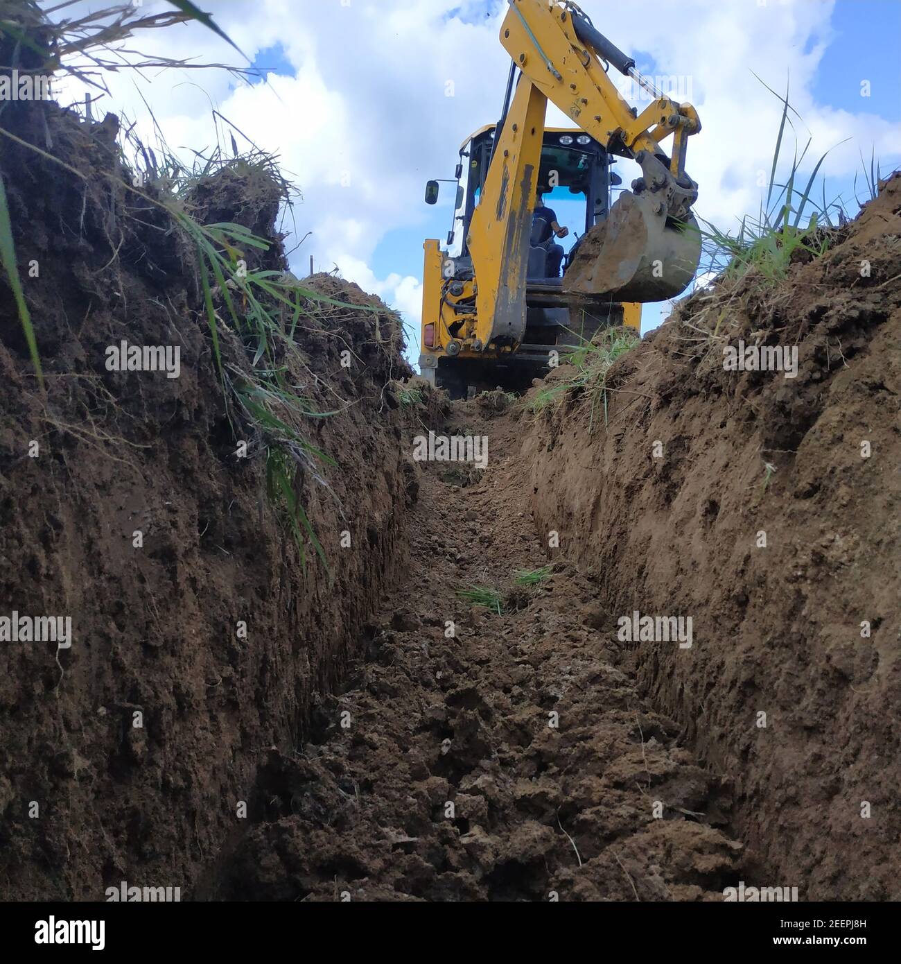 Wiring of an electric cable on the dug trench, supply of the electric ...