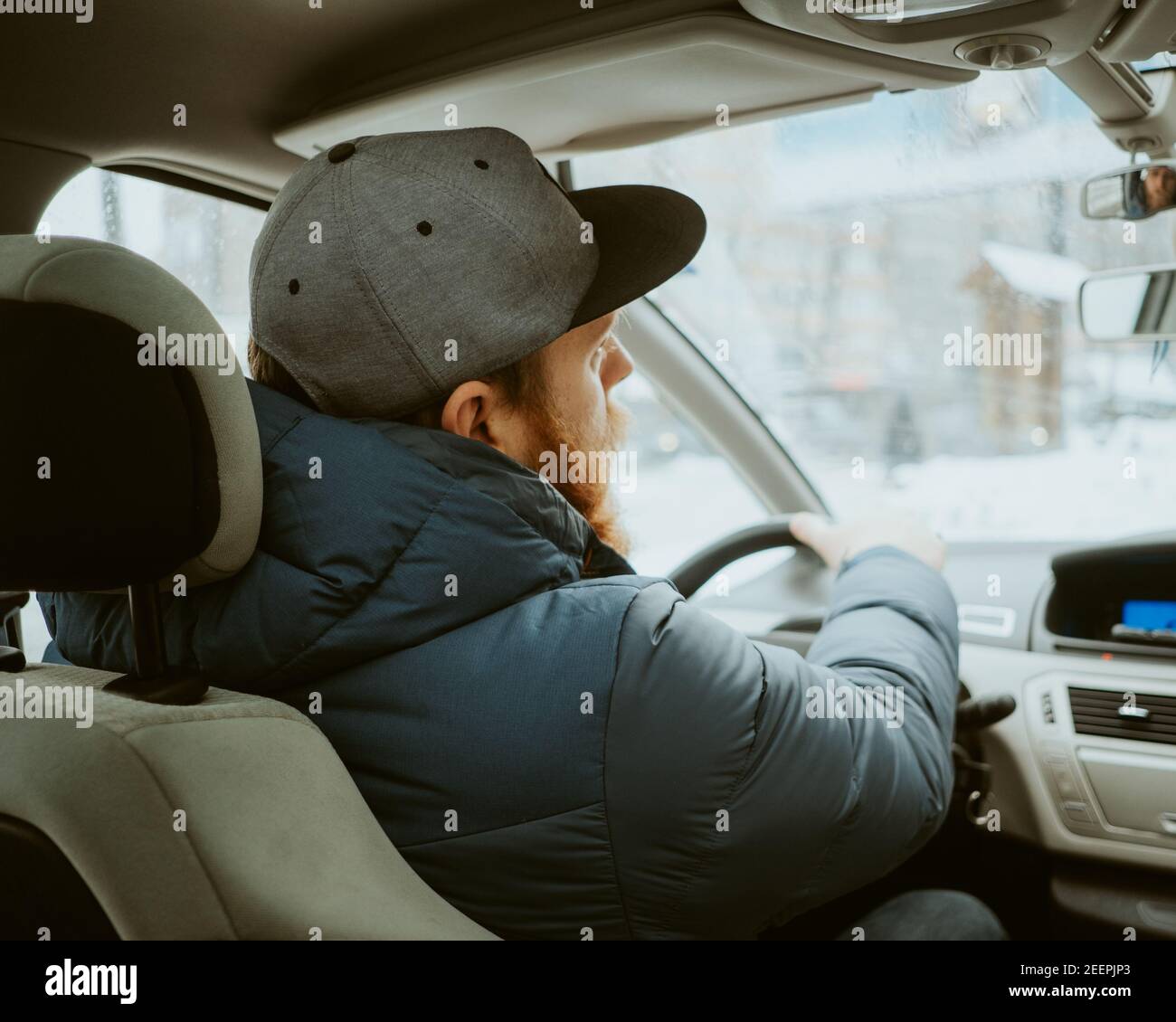 Man driving and looking in front mirror Stock Photo - Alamy