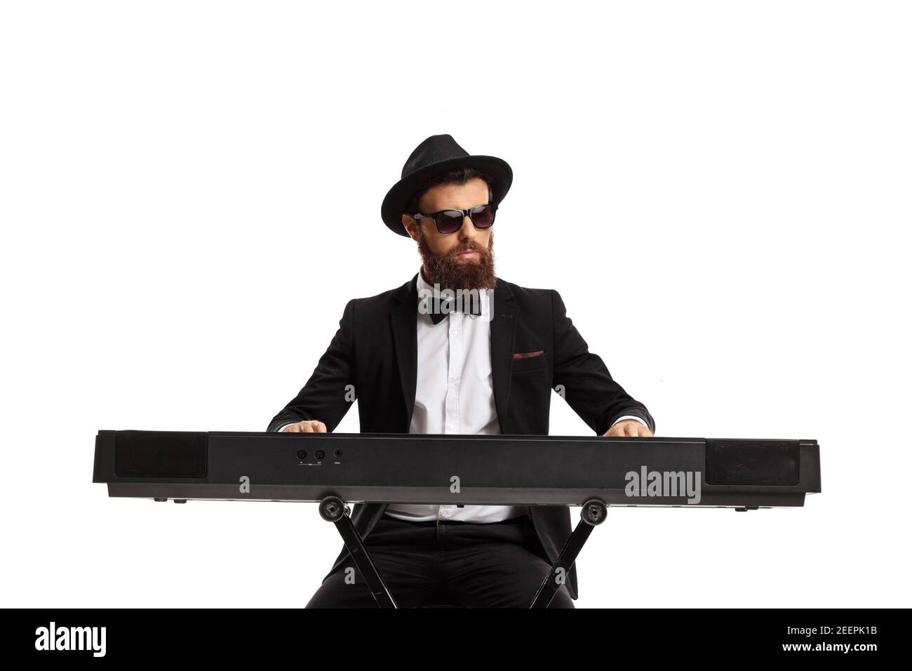 Bearded male musician playing a keyboard isolated on white background ...