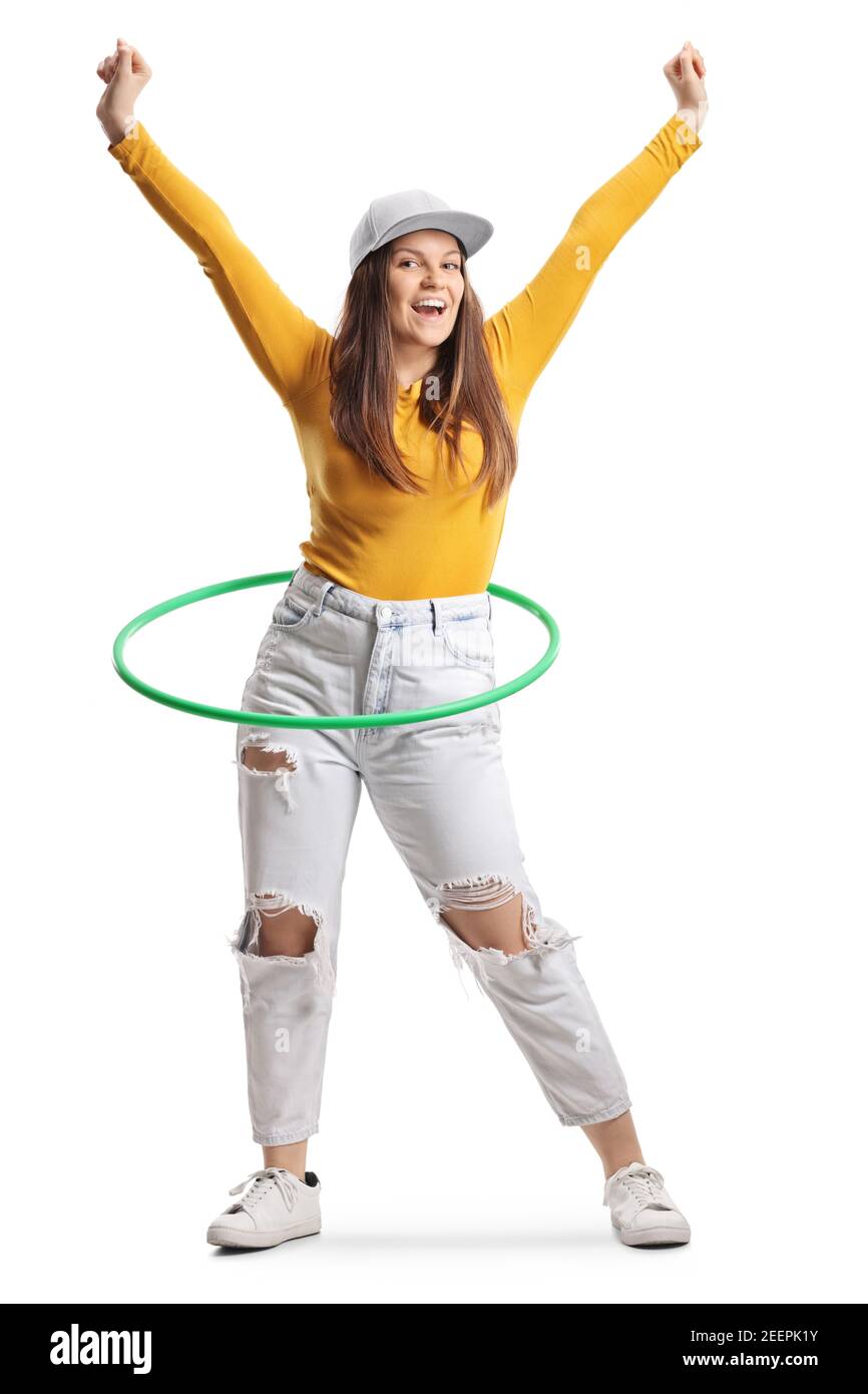 Full length portrait of a young woman spinning a hula hoop and raising ...