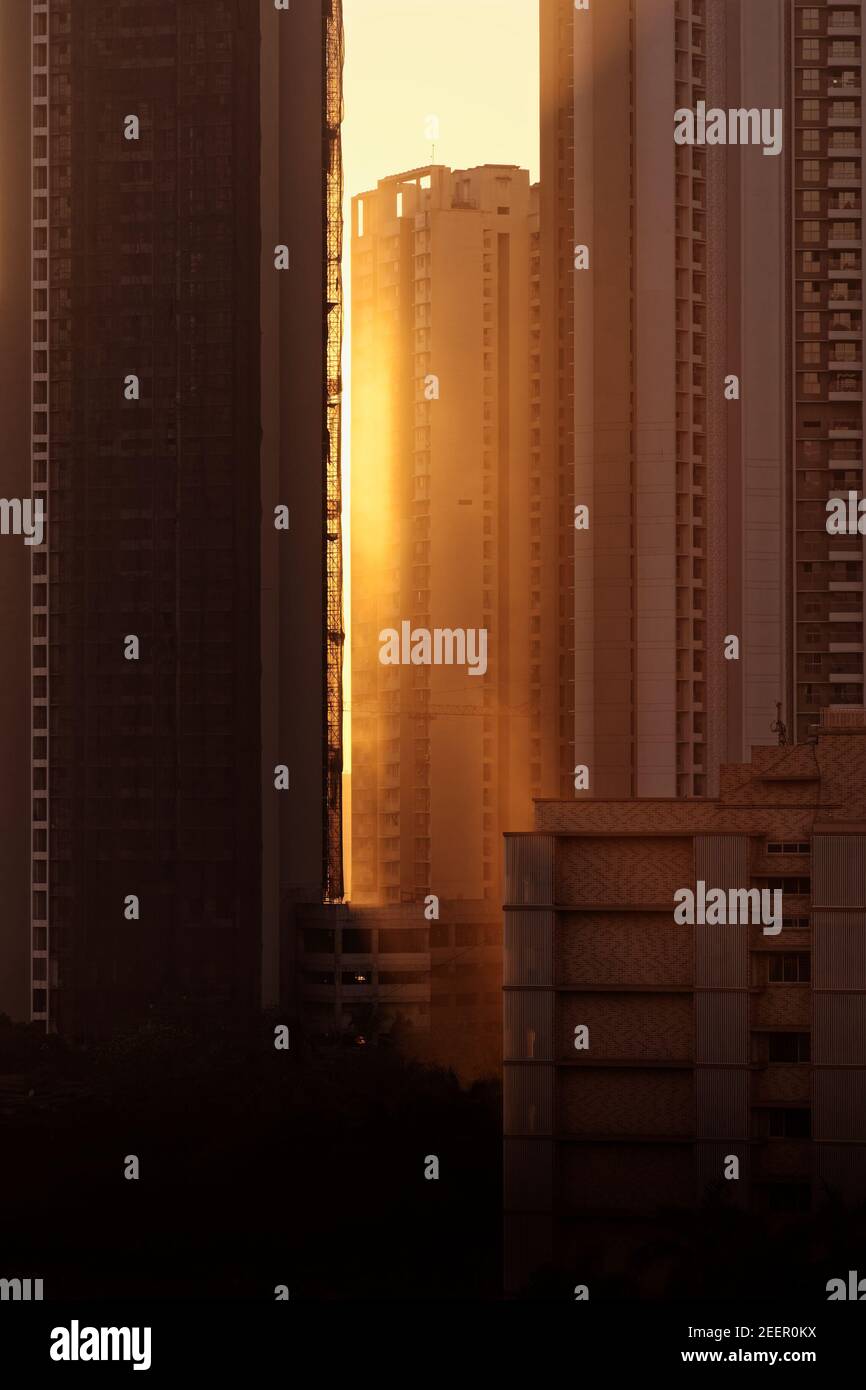 Tall skyscrapers in downtown suburban Mumbai with evening sun rays ...