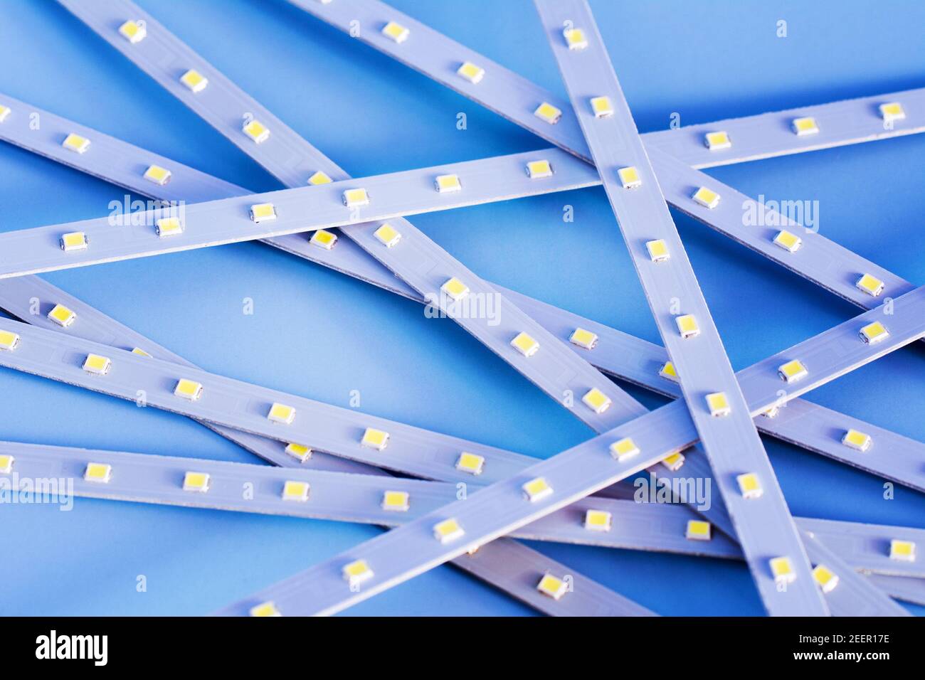 Yellow Led strip closeup on blue background. Spare part for repair lamp ...