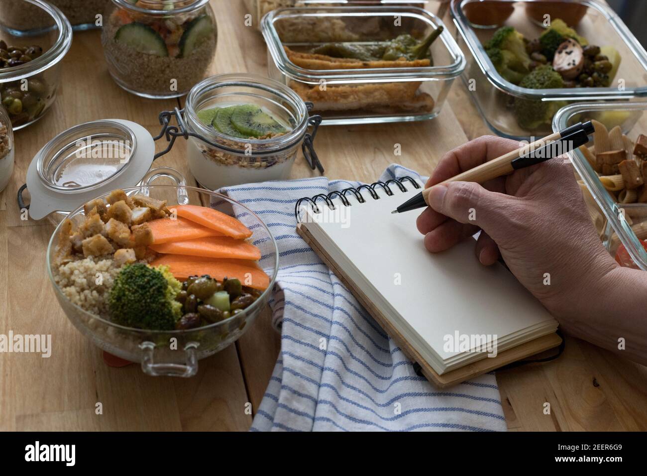 Man hand writing a menu in the middle of a batch cooking scene Stock ...