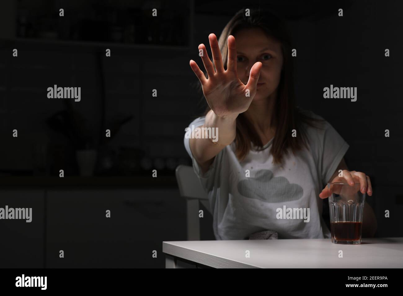 Depressed sad young woman feeling bad drinking whiskey alone at home ...