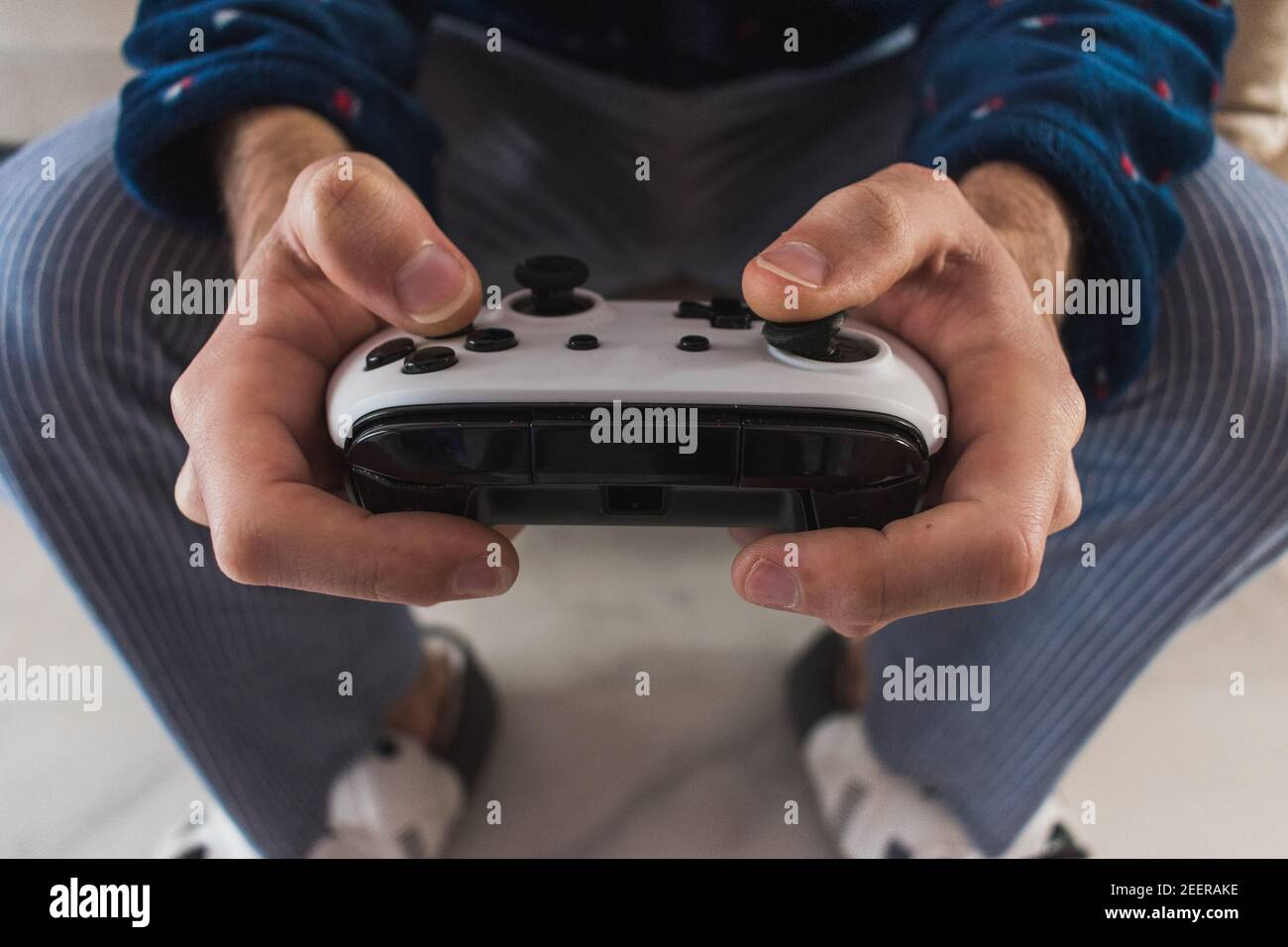man playing with a gamepad console Stock Photo - Alamy