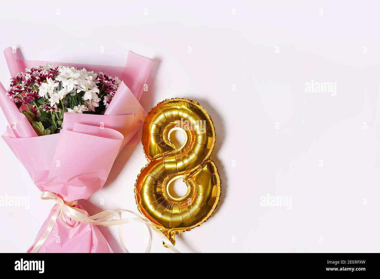 8 golden number ballon with bouquet of flowers. white background. Woman ...
