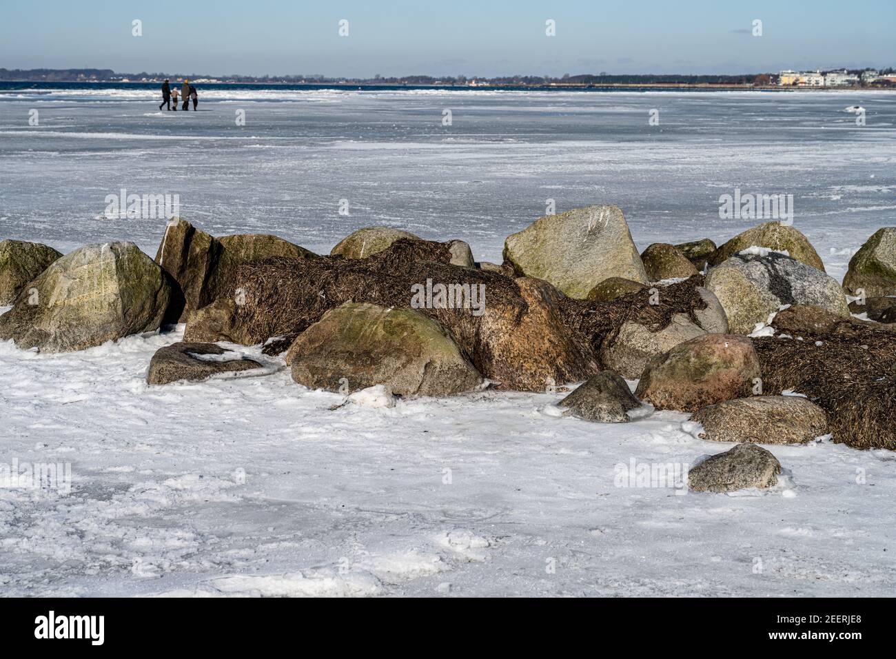 February 14, 2021 - Lomma, Sweden: Ice covering an ocean bay. People ...