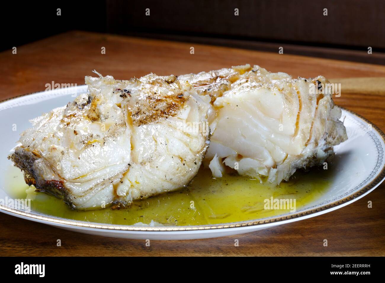 Baked cod with olive oil Stock Photo - Alamy