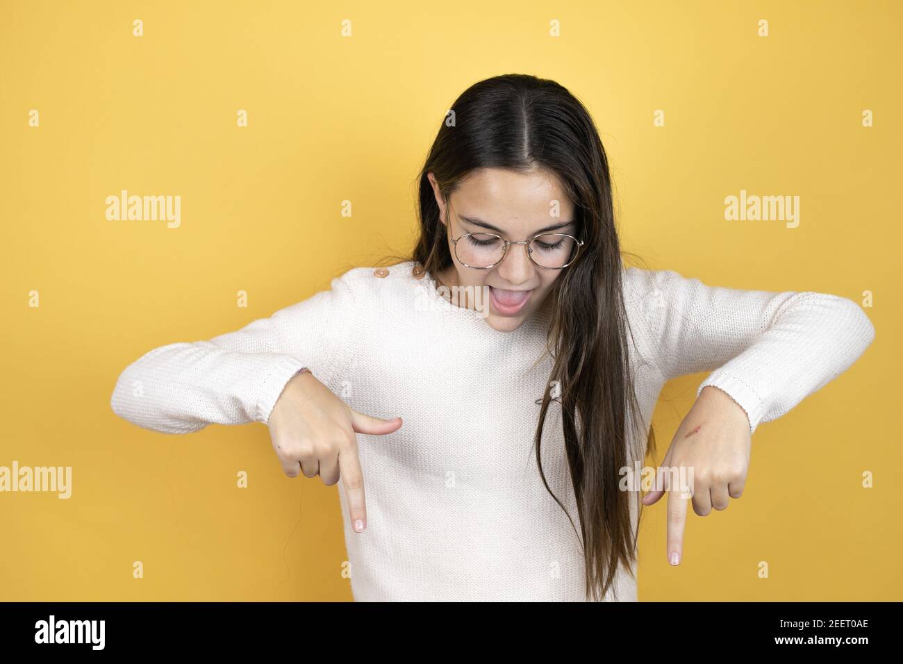 Beautiful child girl wearing casual clothes surprised, looking down and ...