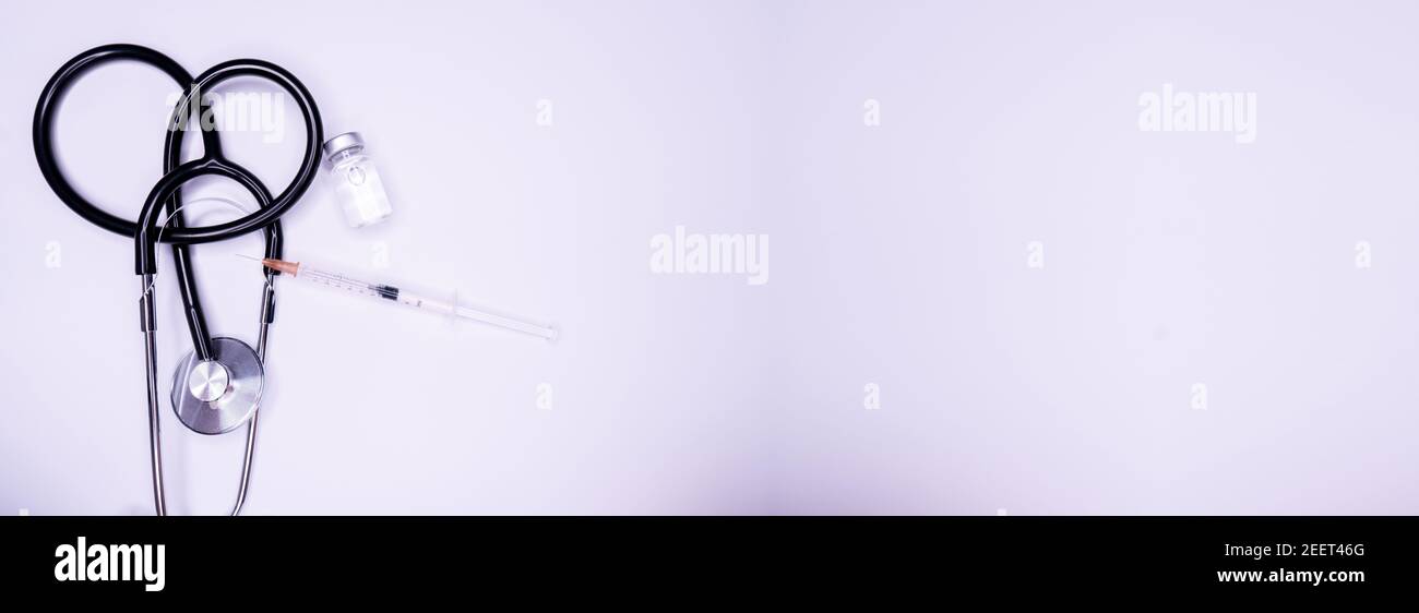 Doctor blue stethoscope for cardiac on white background with syringe ...