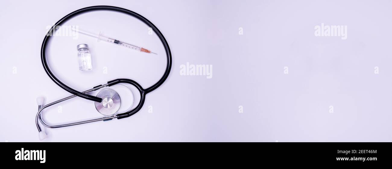 Doctor blue stethoscope for cardiac on white background with syringe ...