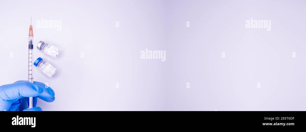 Syringe, medical injection, bottle, ampule in hand, palm or fingers ...