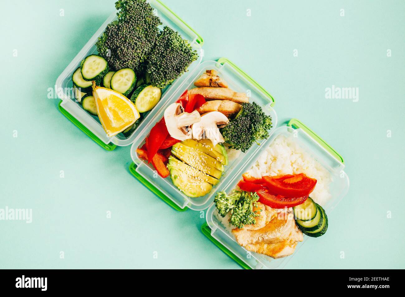 top view of lunch boxes with food on green background Stock Photo - Alamy