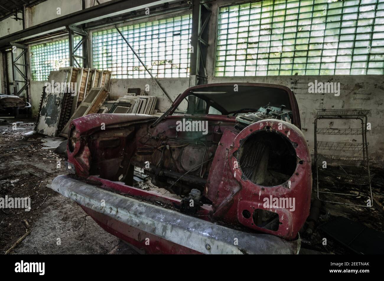 old red car in abandoned workshop Stock Photo - Alamy