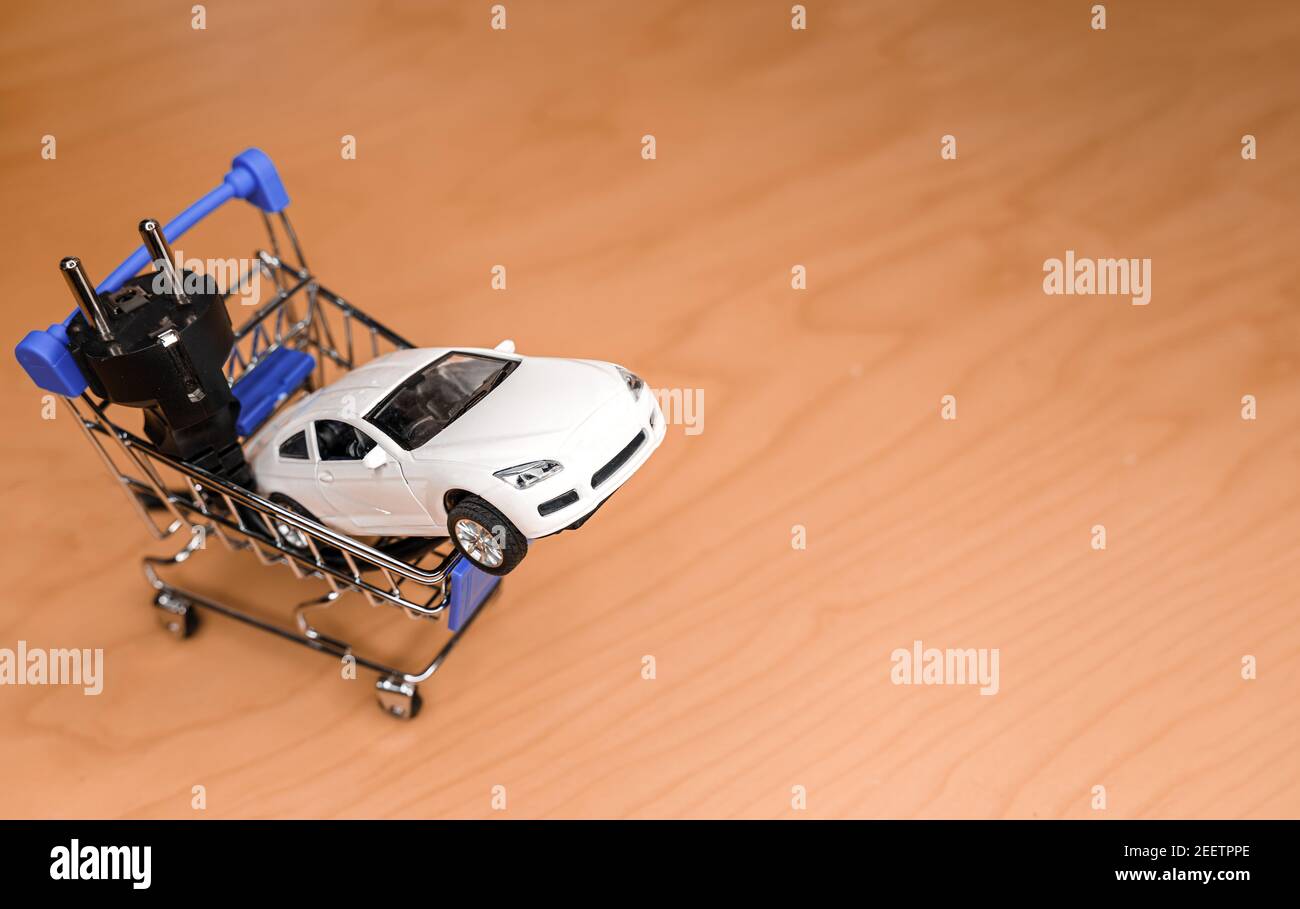 Toy car and electrical plug inside a small shopping cart Stock Photo ...