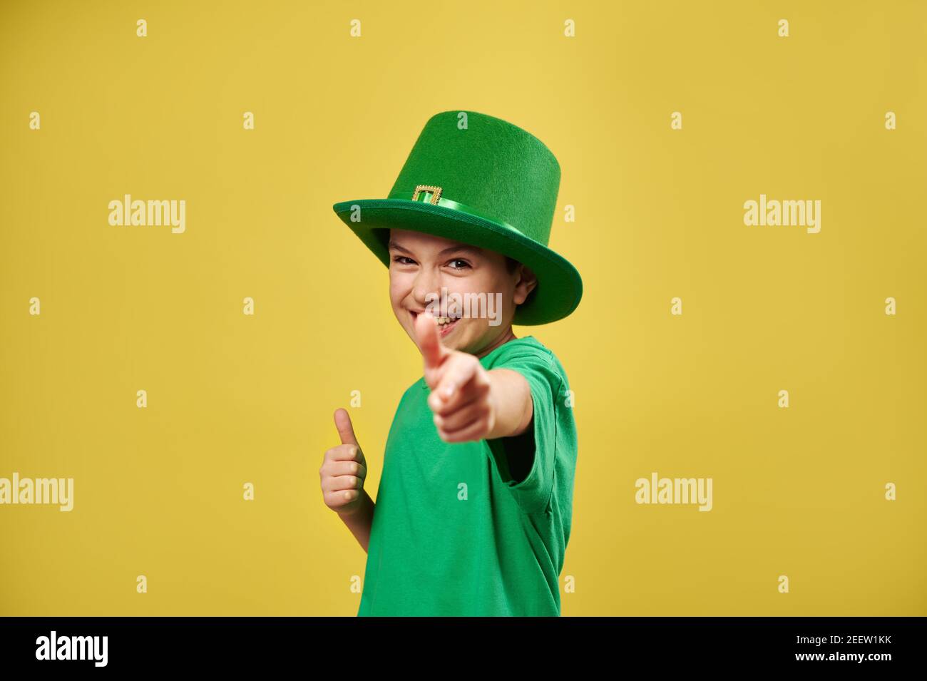 Funny boy pointing finger gun and showing thumb up to camera isolated ...