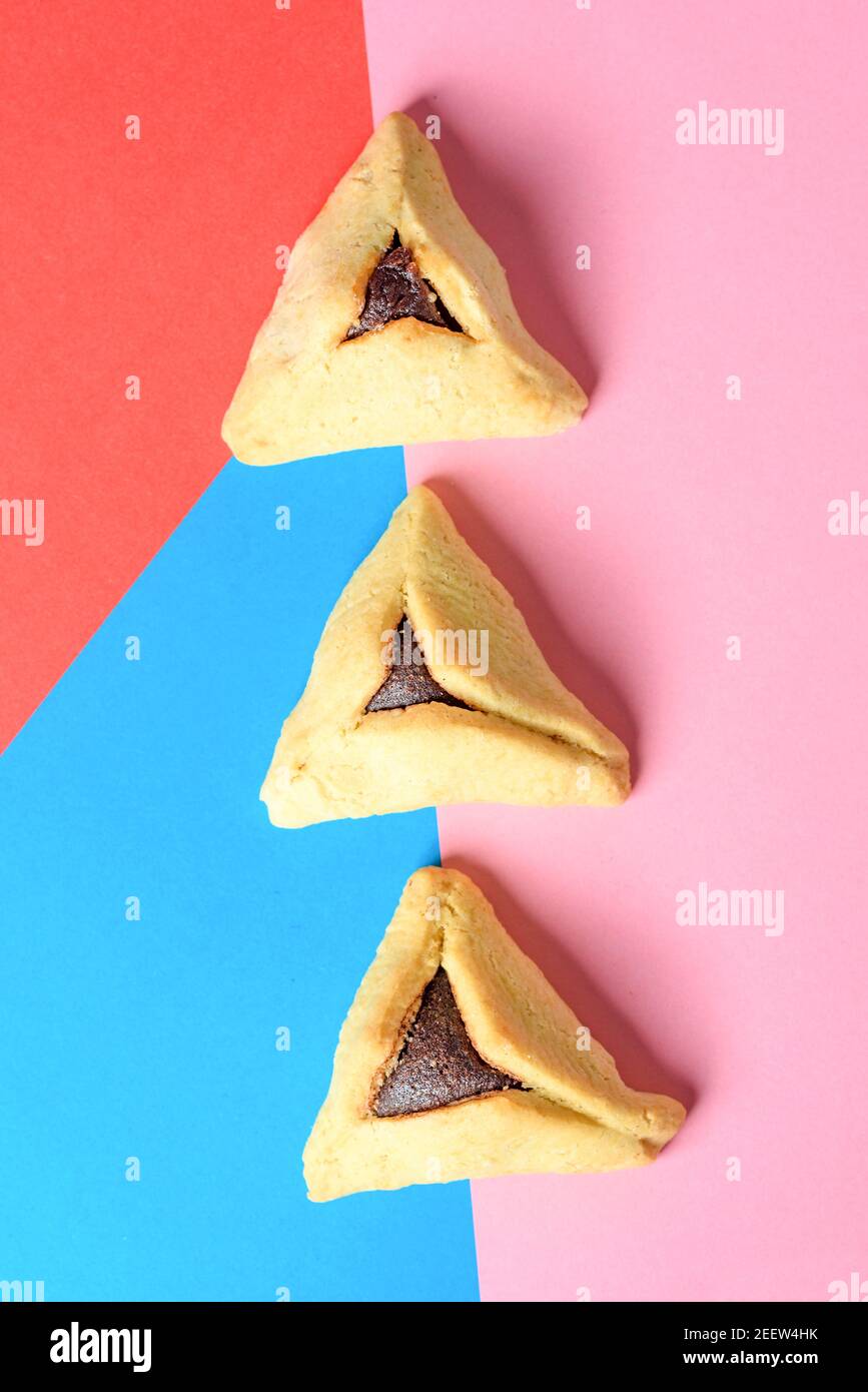 Purim holiday concept. Creative arrangement of variety Hamantash on red ...